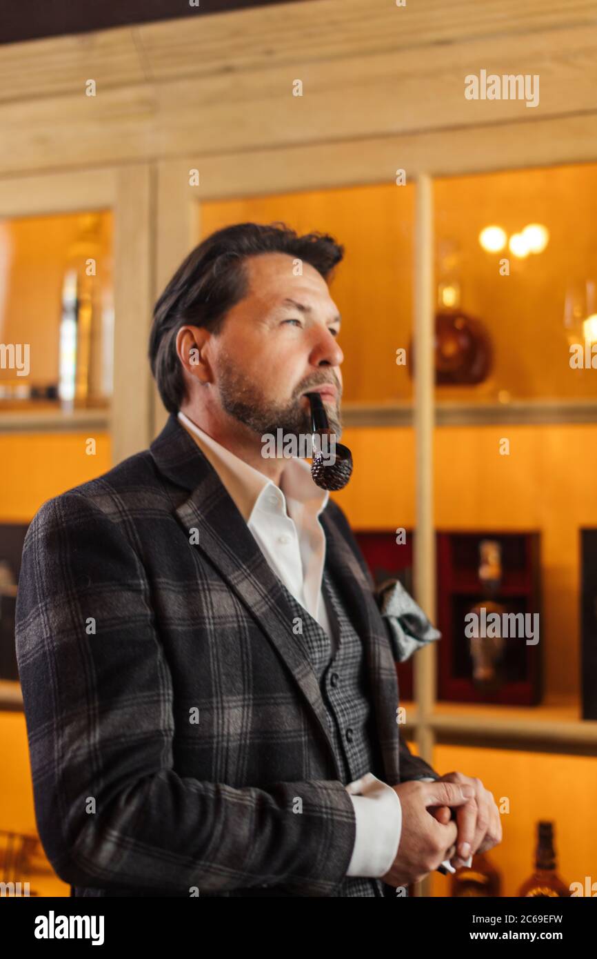 Well-dressed mature caucasian small business owner in expensive ...
