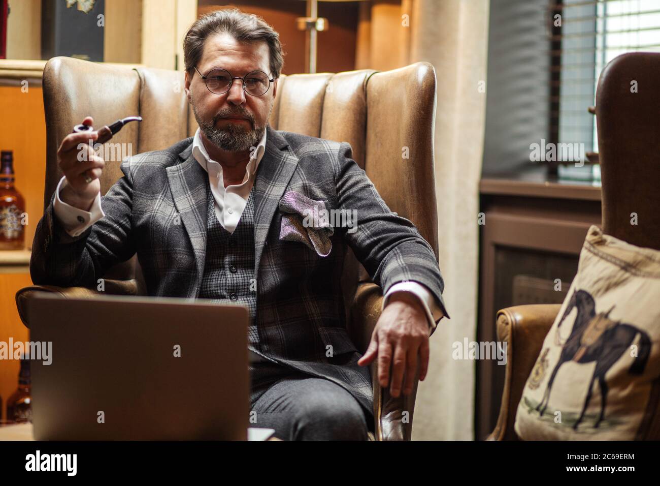 Serious executive manager in white shirt and tailored suit concentrated ...