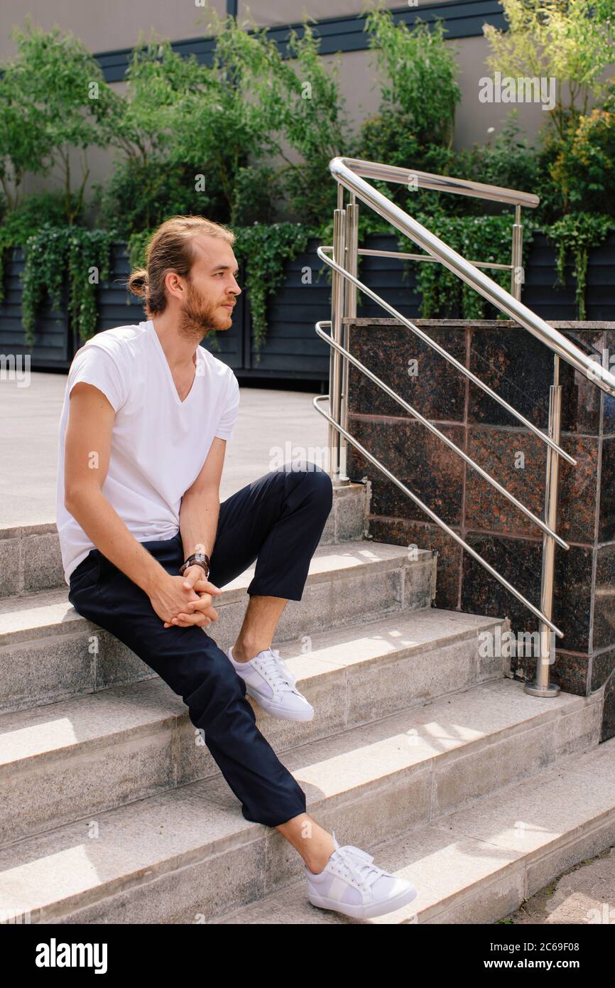 Man sitting stairs side view hi-res stock photography and images - Alamy
