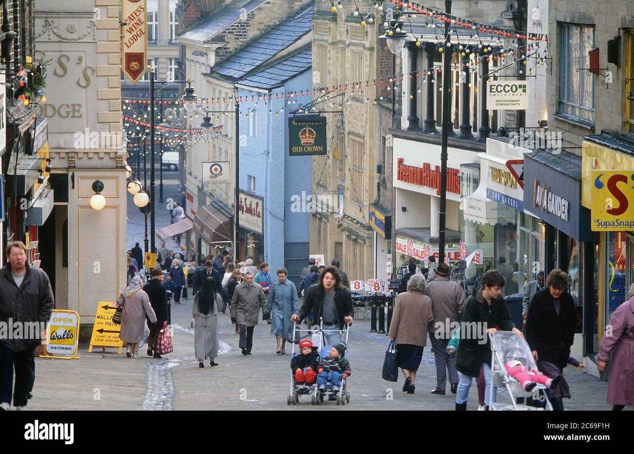 Woman with twins in a stroller pushchair walking up Ivegate, Bradford ...