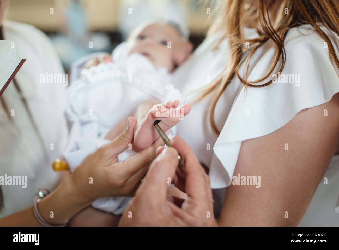 baptism ceremony in the church. priest performing a ritual Stock Photo ...