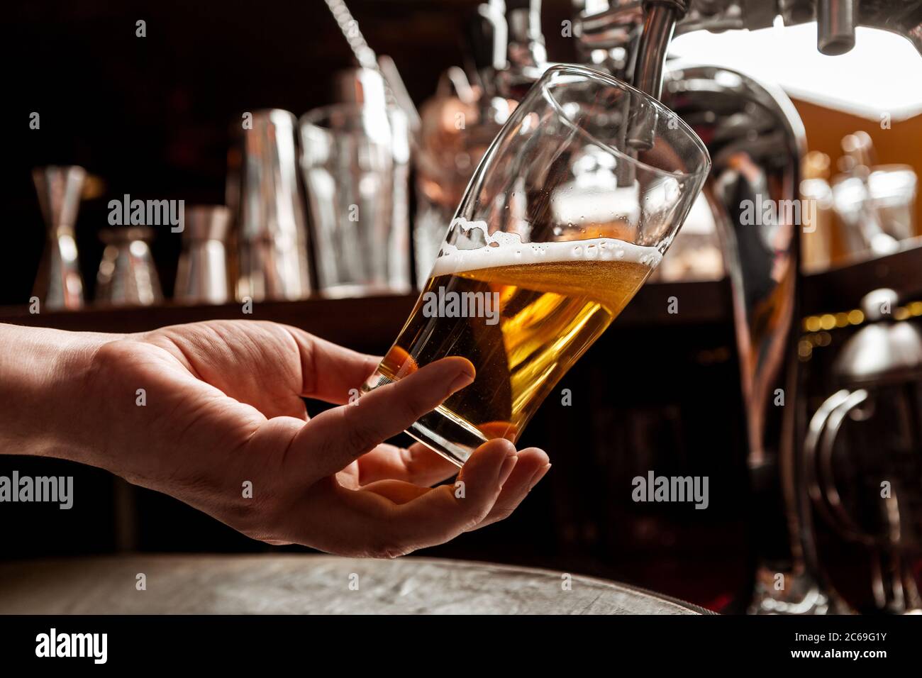 Bartender pours dark beer in hi-res stock photography and images - Alamy