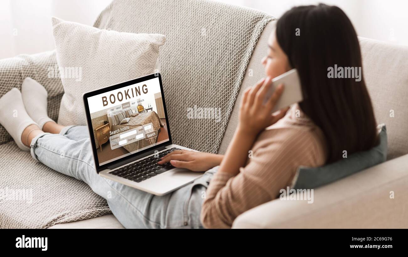 Girl booking hotel online, talking on phone with reservation team Stock ...