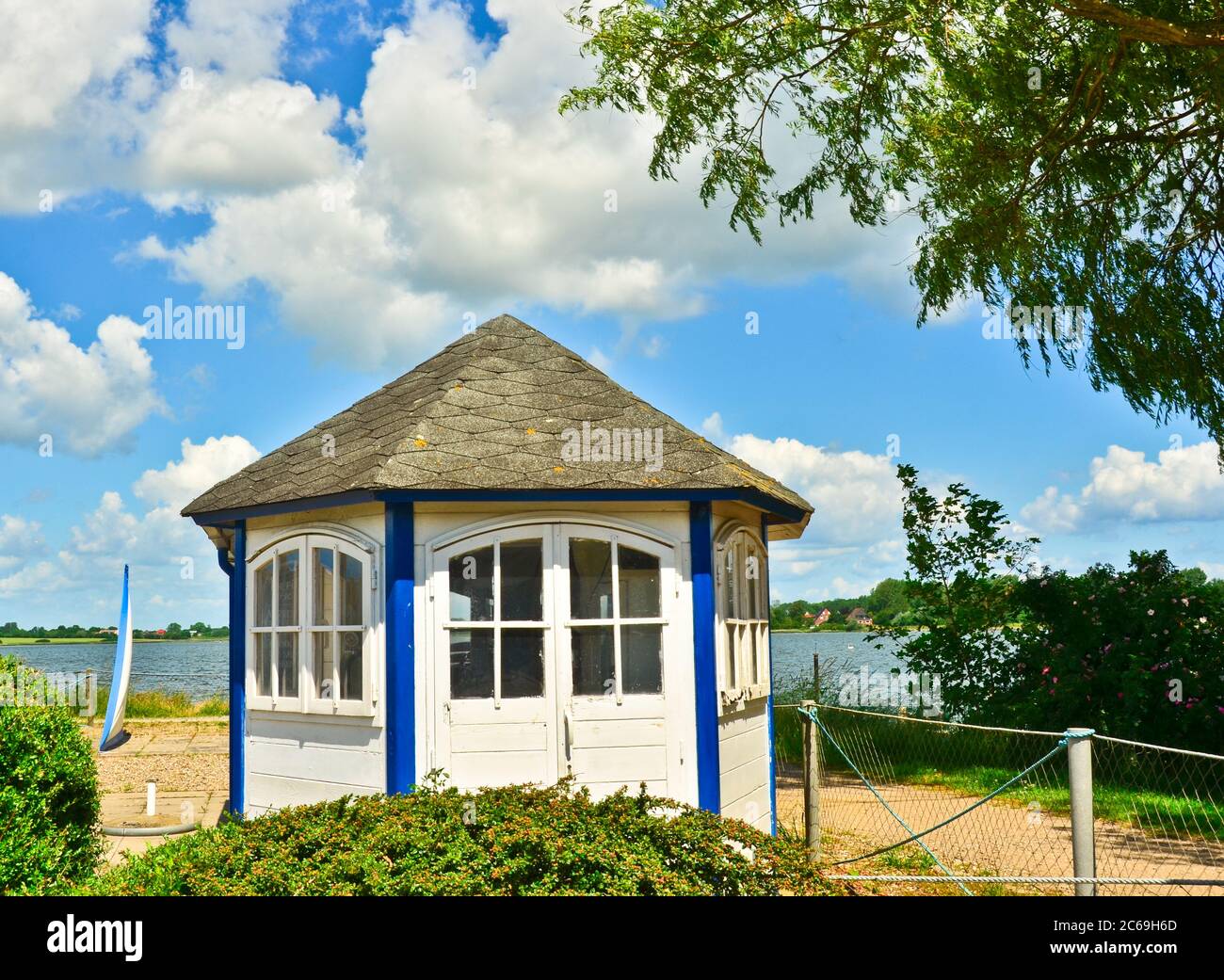 A light blue and white wooden small shed, pavilion, hexagonal at the ...