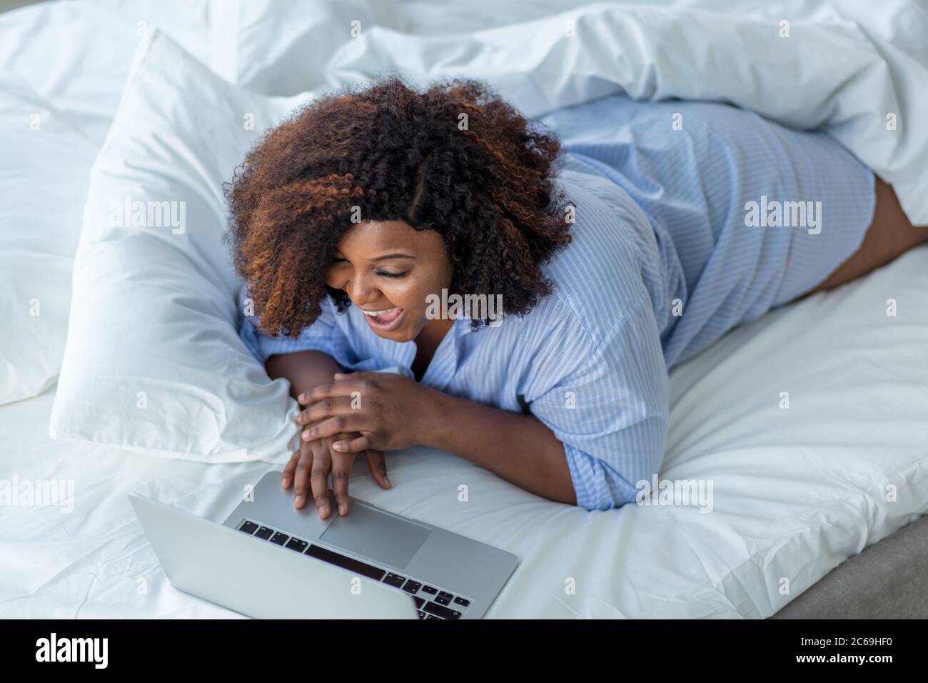 happy girl working with a computer at home. close up photo. free time ...