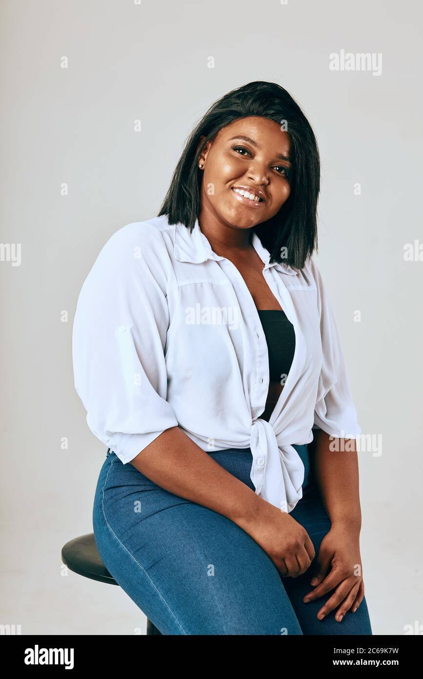Happy african overweighted woman posing isolated over white studio ...