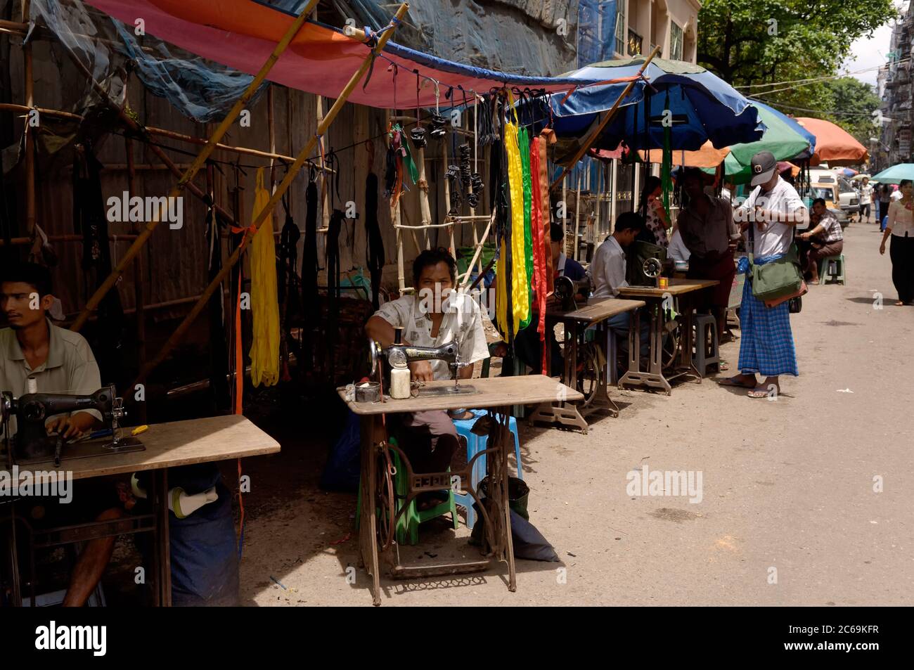 Seamster, man sewing with classic sewing machine, Yangon market ...