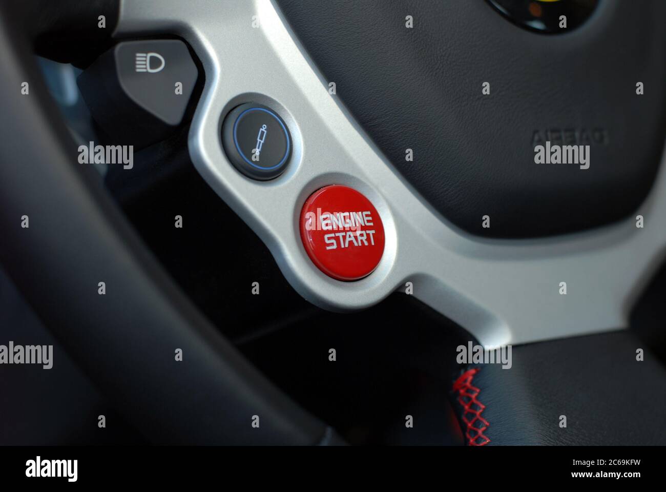 Start stop engine button on a modern sports car steering wheel Stock ...