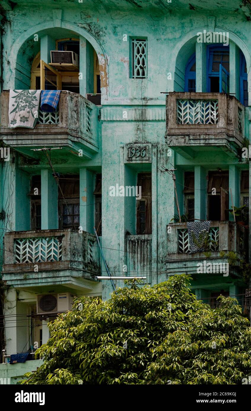 Aging buildings dwellings in central Yangon, decaying paint and ...