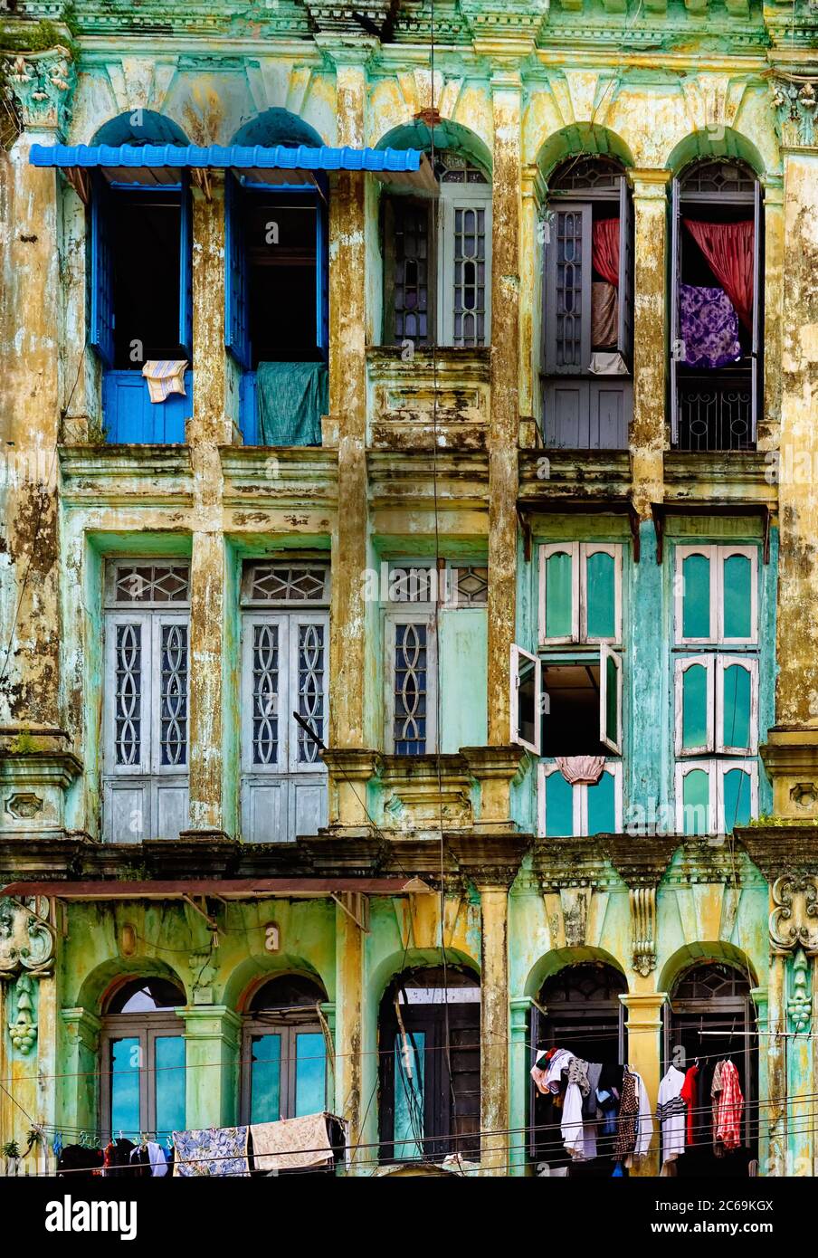 Aging buildings dwellings in central Yangon, decaying paint and ...