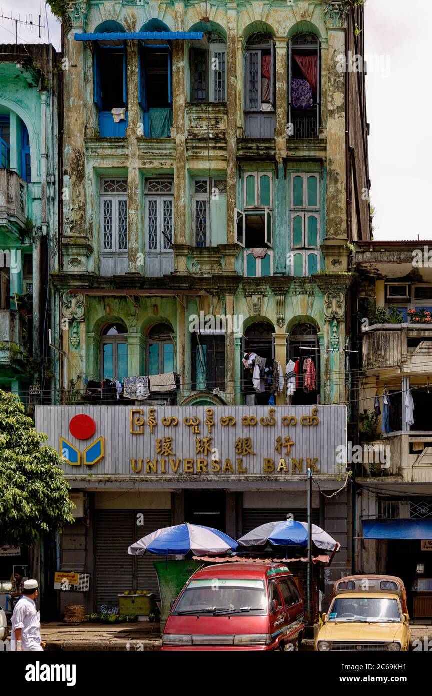 Aging buildings dwellings in central Yangon, decaying paint and ...