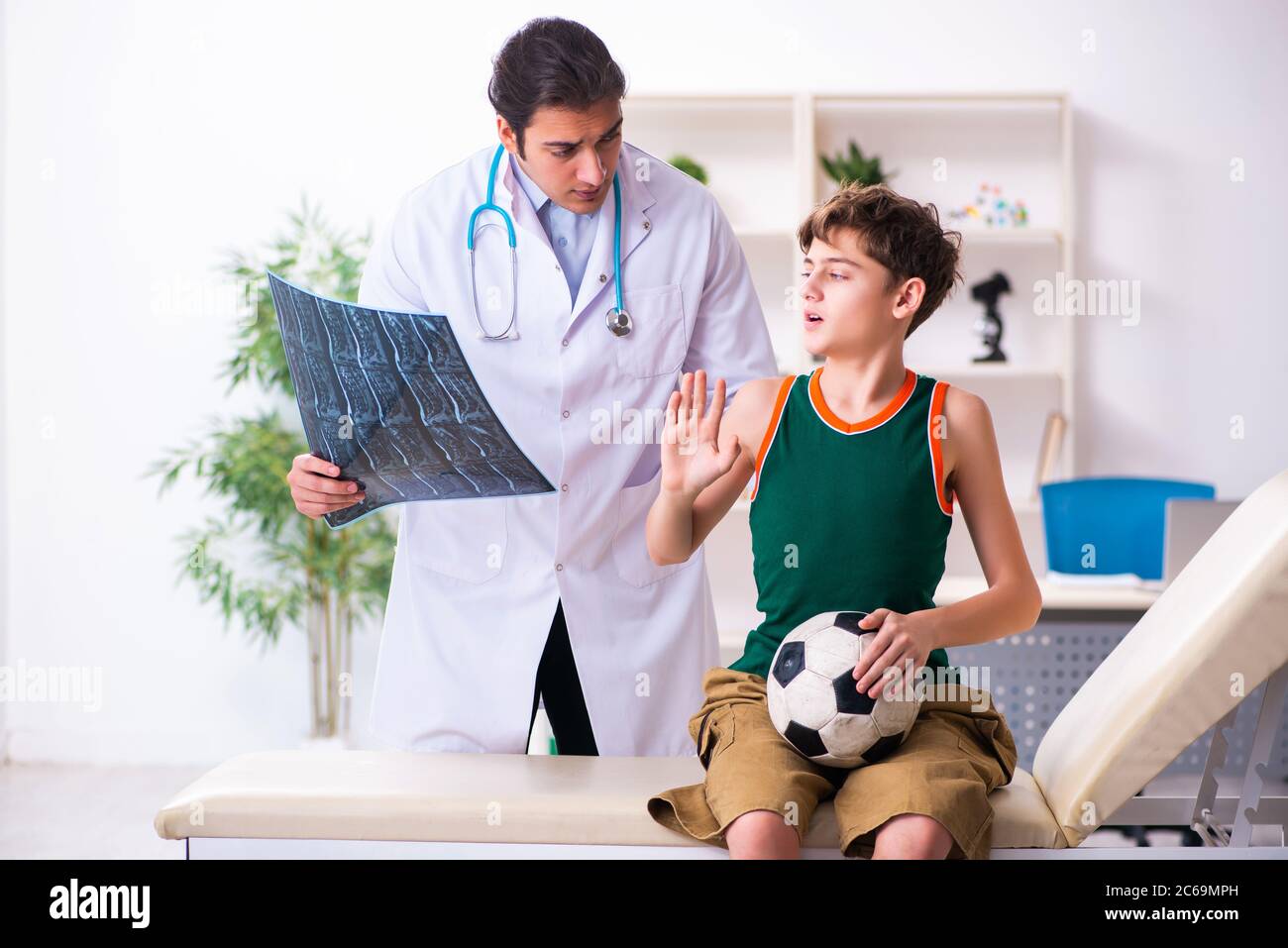 Sick boy visiting young doctor pediatrician Stock Photo - Alamy