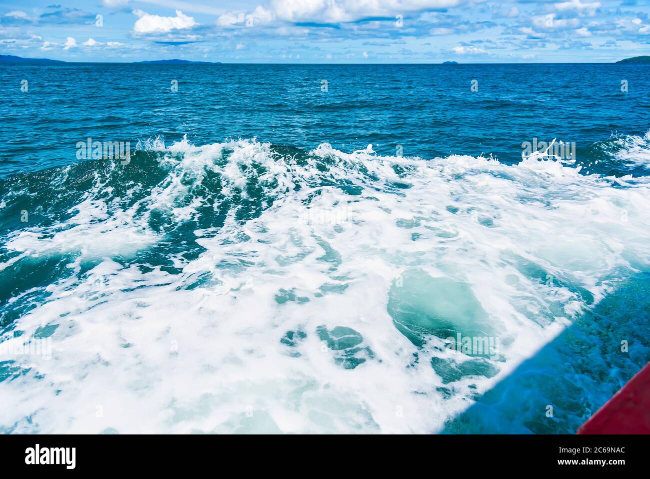 Water blue ocean splash and boat in the sea way ,Waves splashing on the ...