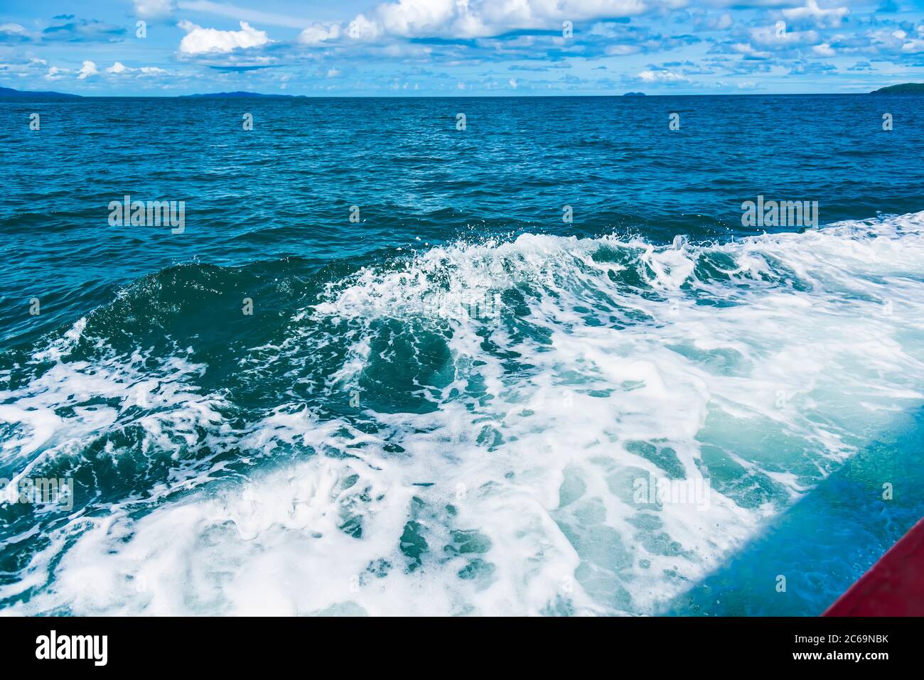 Water blue ocean splash and boat in the sea way ,Waves splashing on the ...