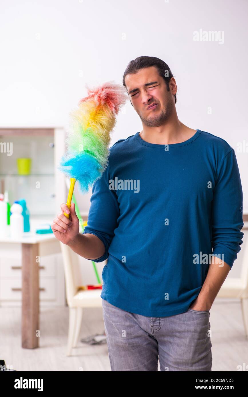 Young man husband doing housework at the home Stock Photo - Alamy