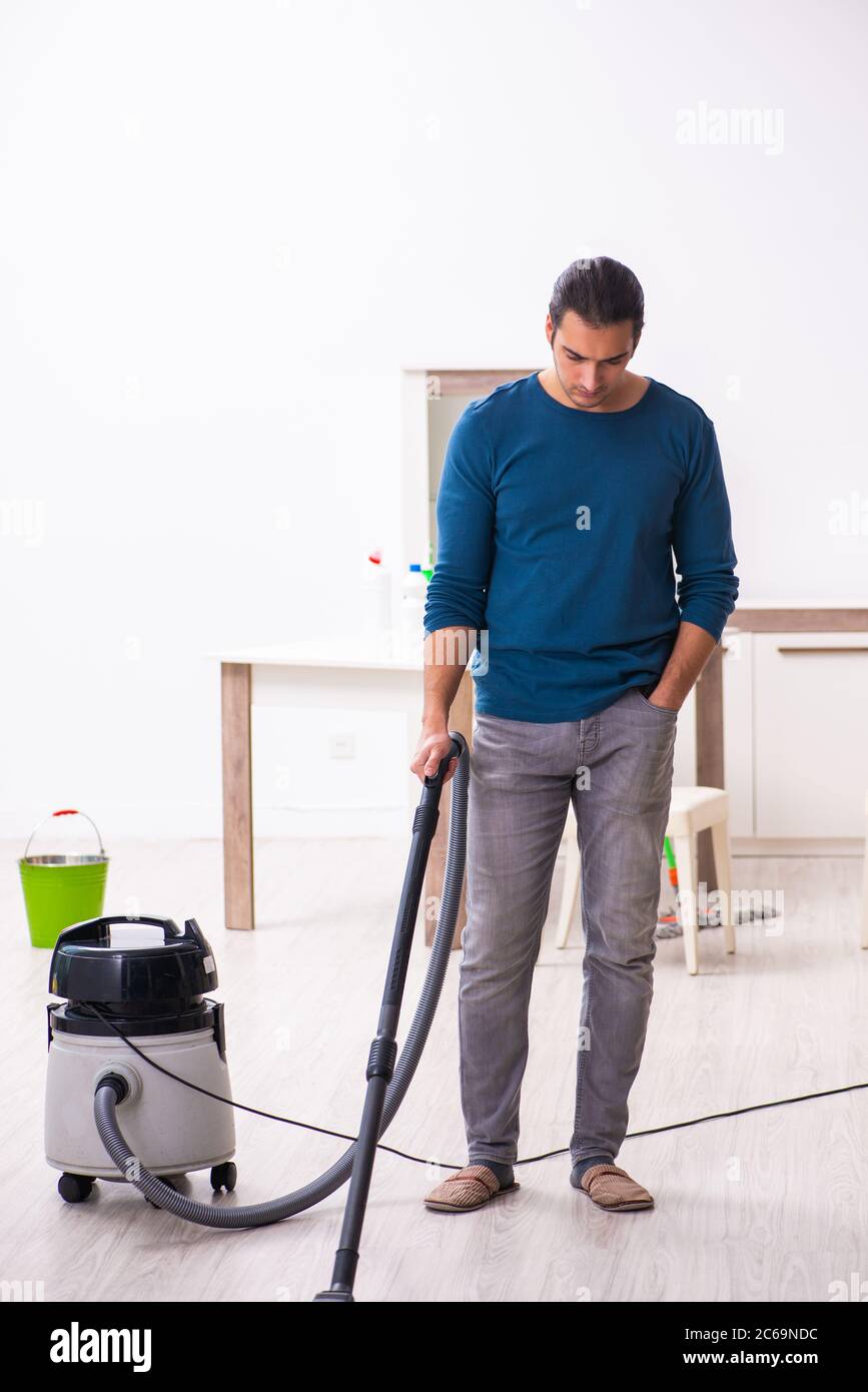Young man husband doing housework at the home Stock Photo - Alamy