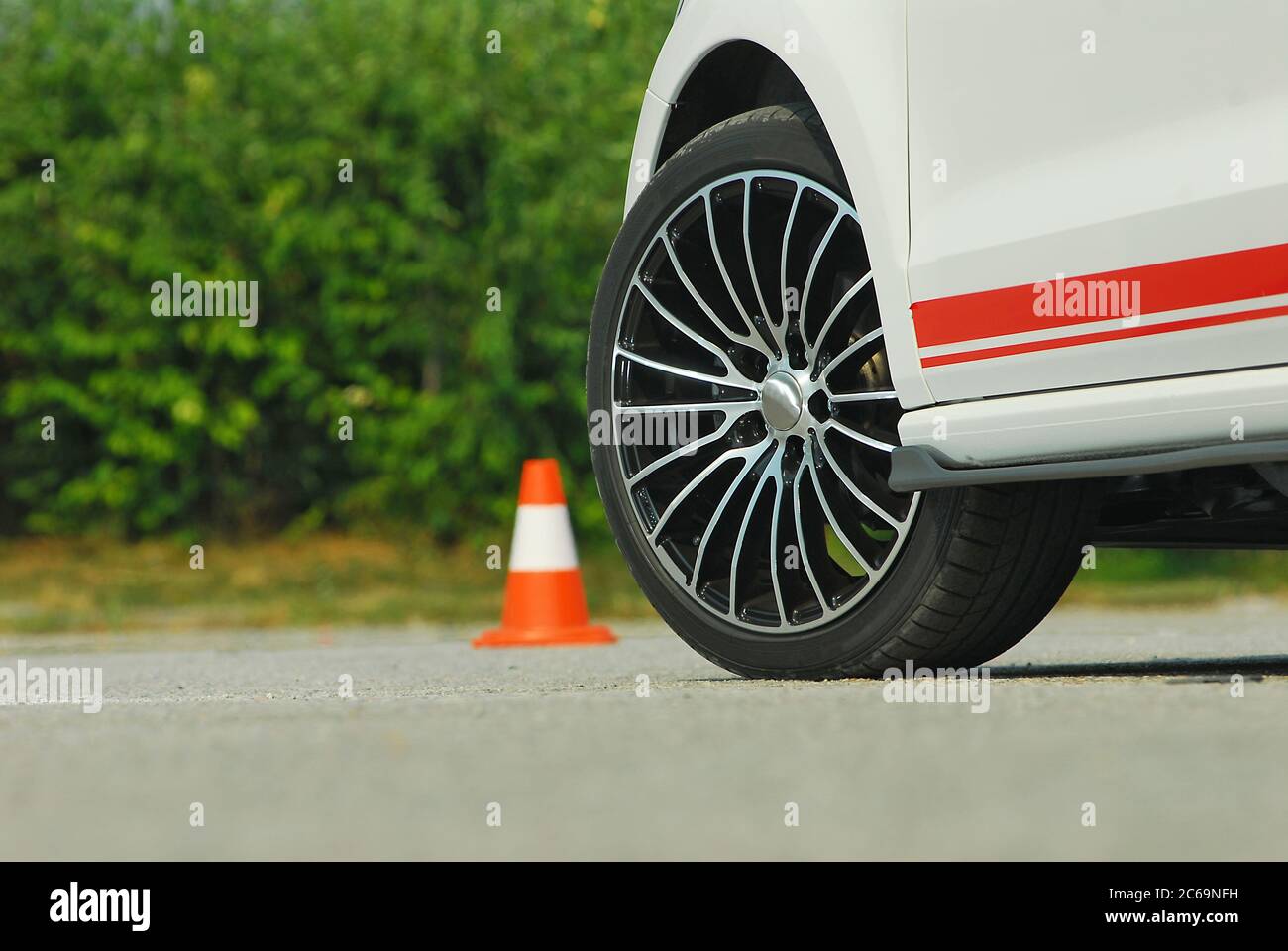 tuned small sports car and wheel with cone Stock Photo - Alamy