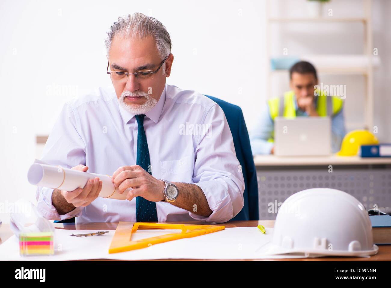 Two architects working in the office Stock Photo - Alamy