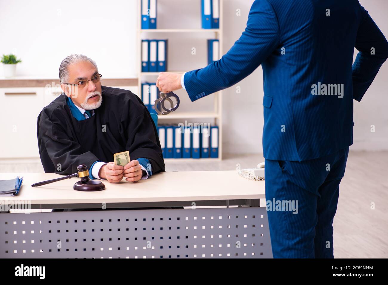 Police inspector arresting judge in court Stock Photo - Alamy