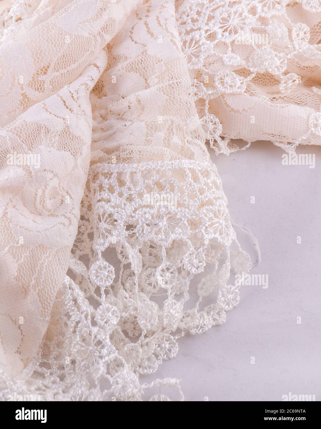Closeup of crumpled cream lace on white background Stock Photo - Alamy
