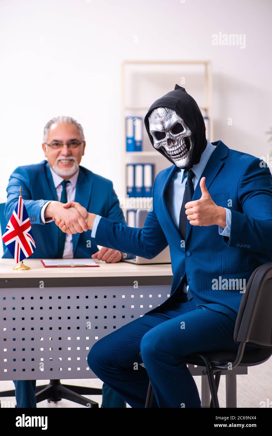 Old businessman employee making deal with the devil Stock Photo - Alamy