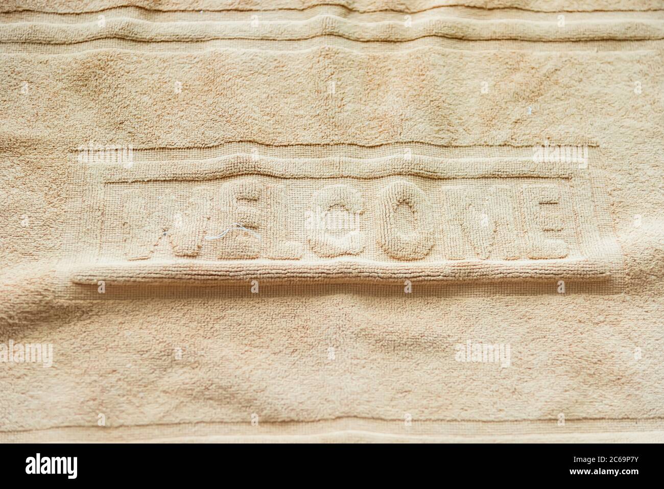 Foot towel with welcome sign on the bathroom floor Stock Photo - Alamy