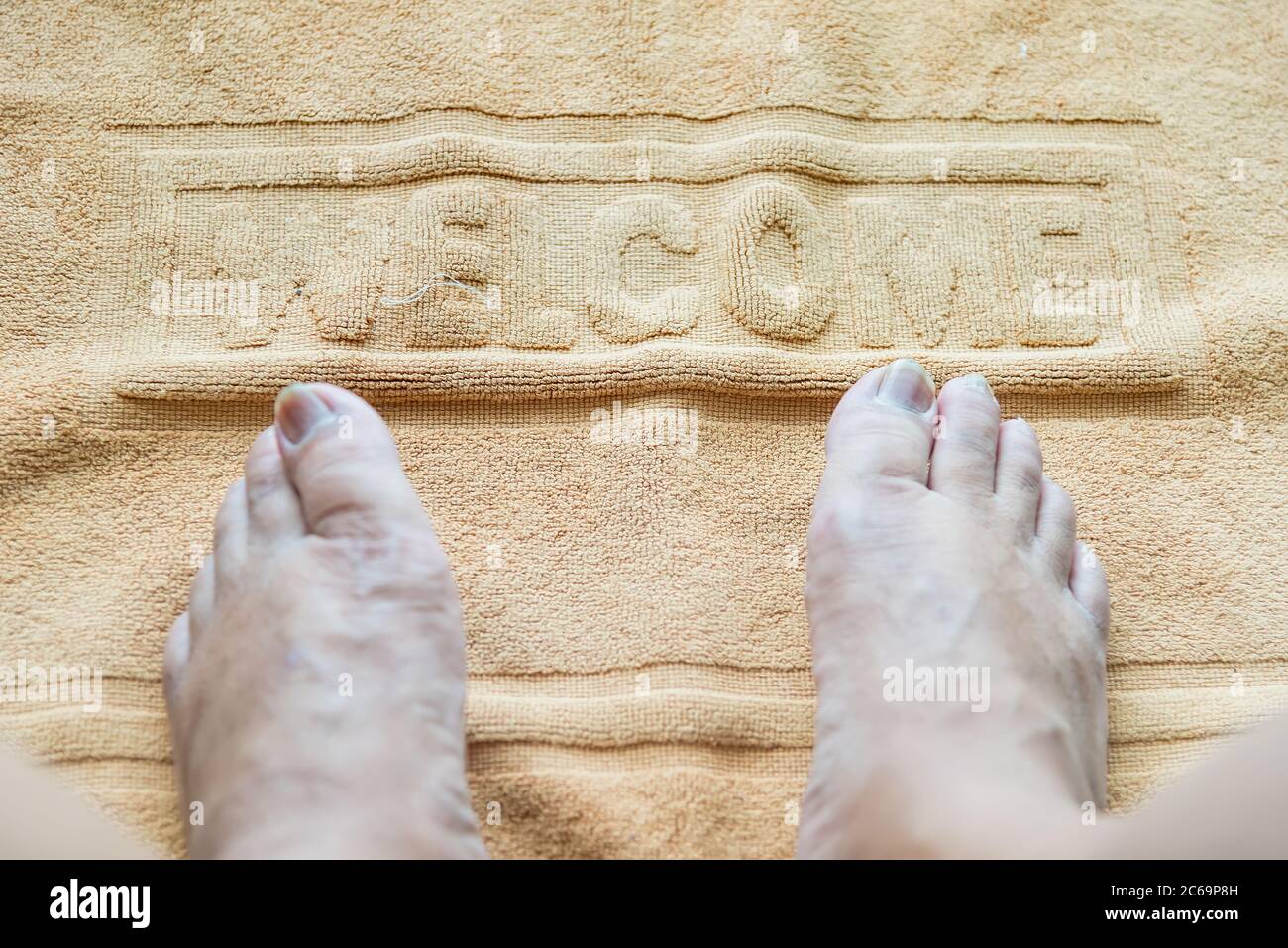 Foot towel with welcome sign on the bathroom floor Stock Photo - Alamy