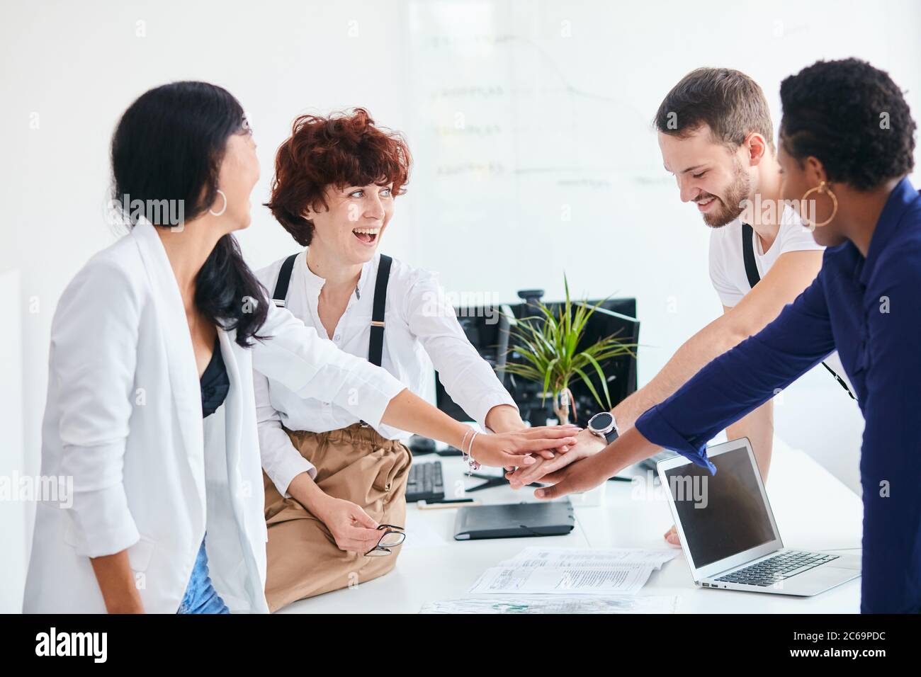 Successful joint work together of interracial team, sitting in white ...