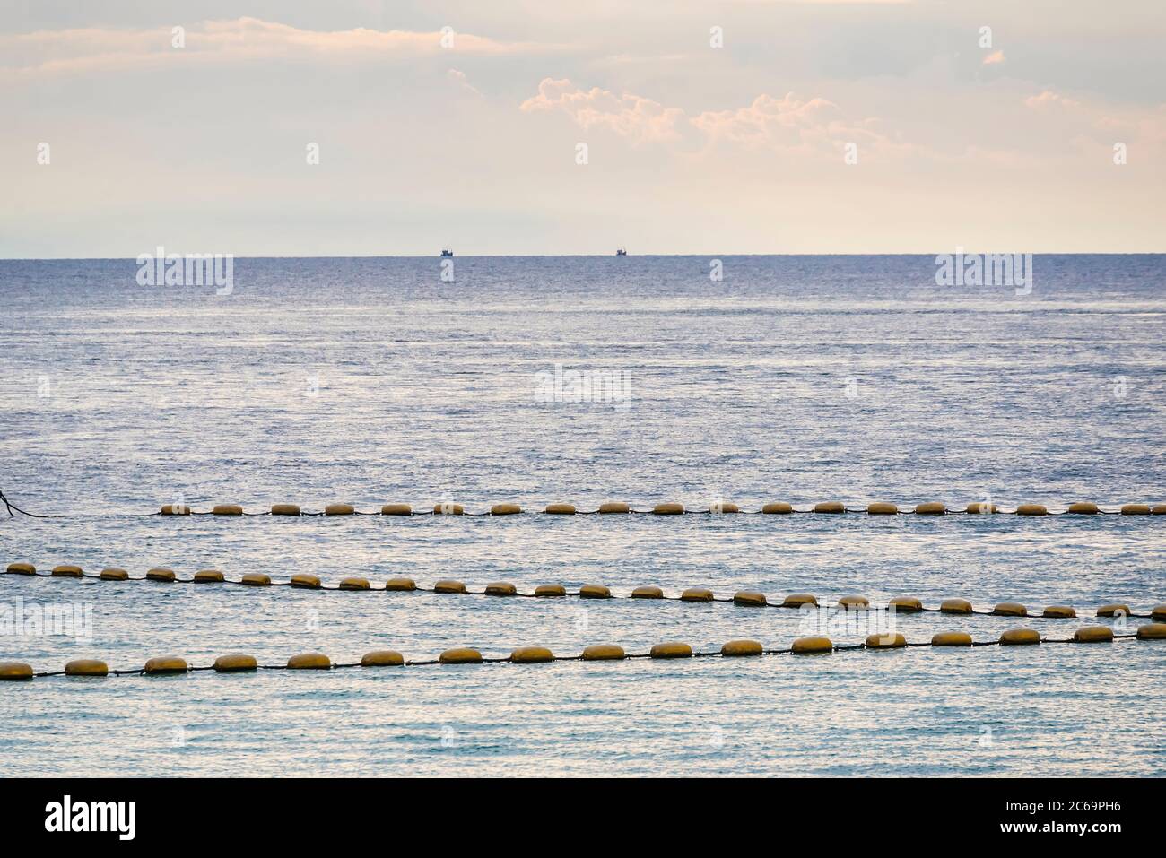 Yellow buoyancy on the beach, sign warning dangerous Stock Photo - Alamy