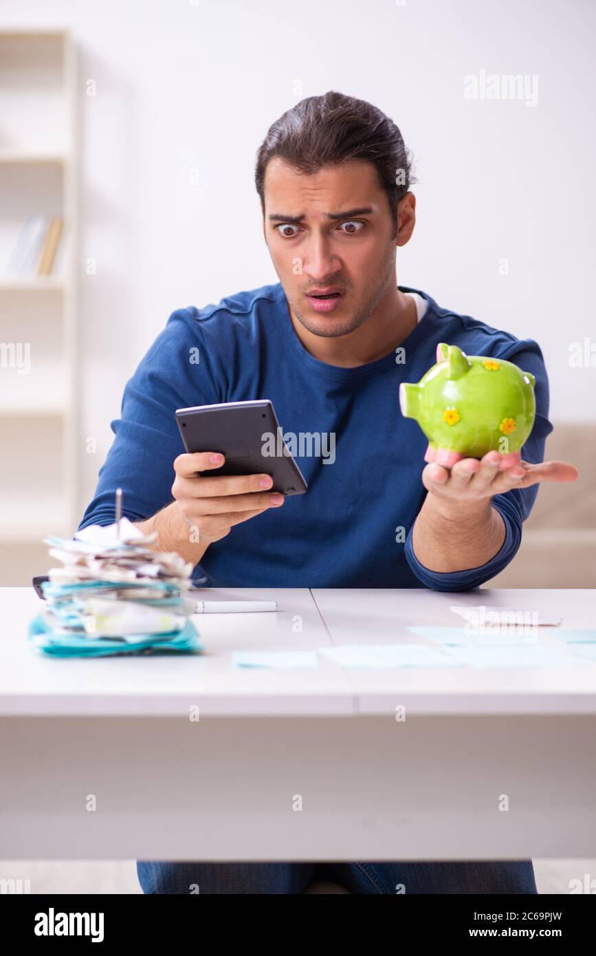 Young man in the budget planning concept Stock Photo - Alamy