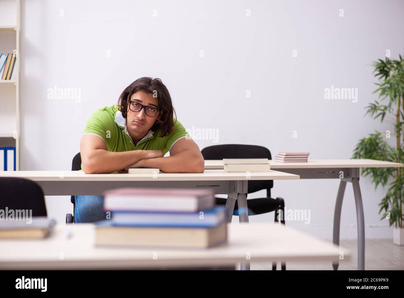 Young male student in the classroom studying Stock Photo - Alamy