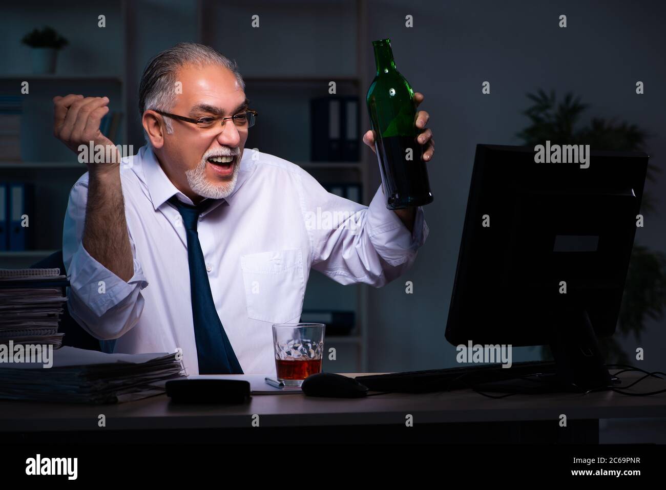 Old employee working late in the office Stock Photo - Alamy
