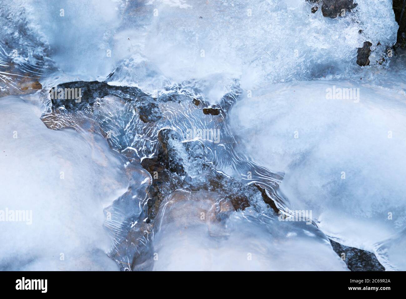 Surface of a frozen winter brook covered with ice Stock Photo - Alamy