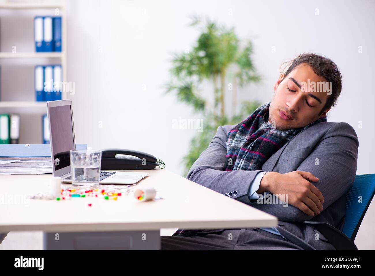 Young employee suffering at workplace Stock Photo - Alamy