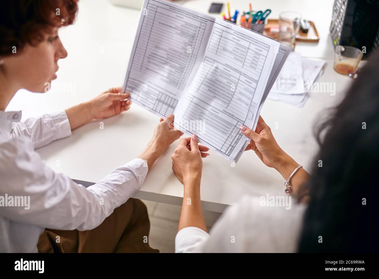 Two female hands holding paper related to work, working process ...