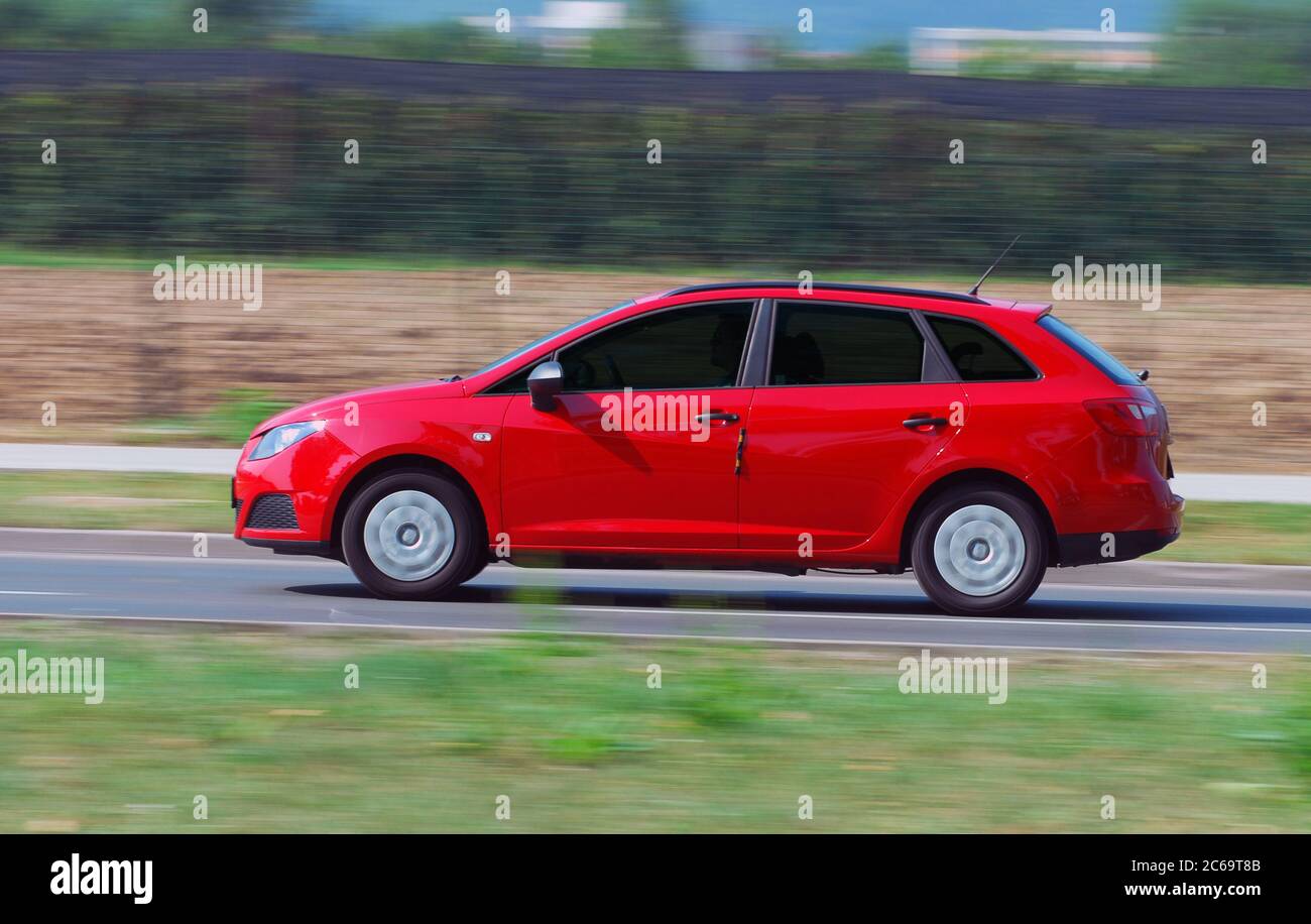 moving car, red station wagon photographed in motion Stock Photo - Alamy