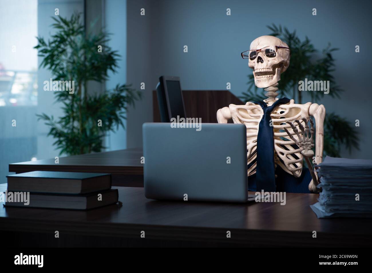 Young employee working in the office night time Stock Photo - Alamy