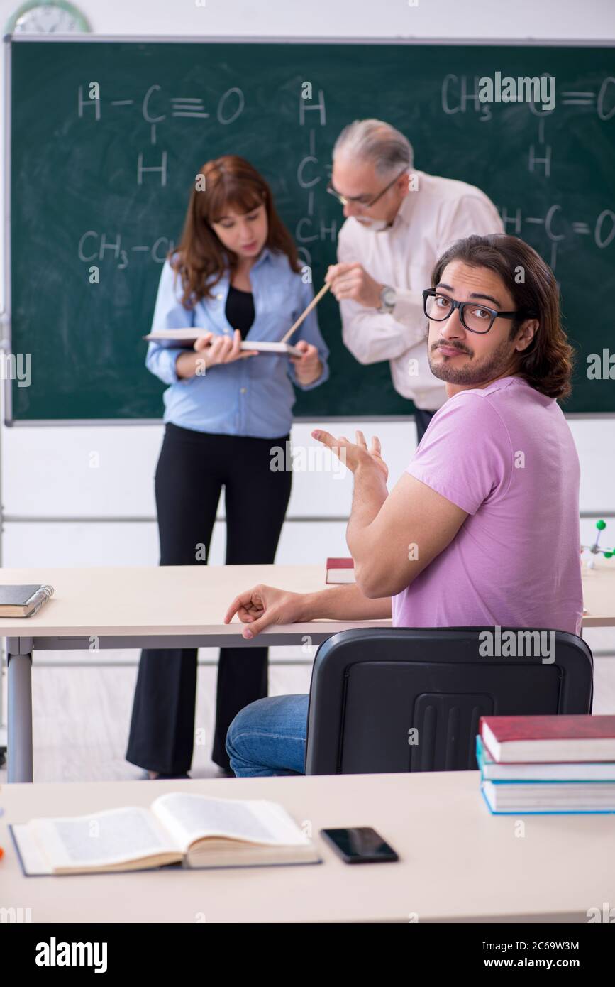 Old teacher and two students in the classroom Stock Photo - Alamy