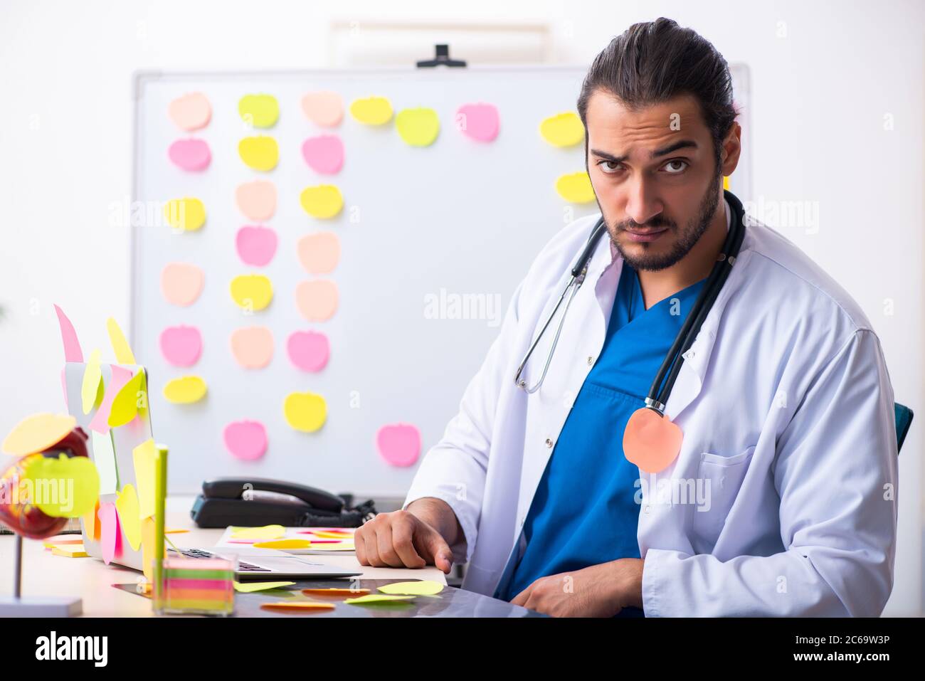 Young medic in conflicting priorities concept Stock Photo - Alamy