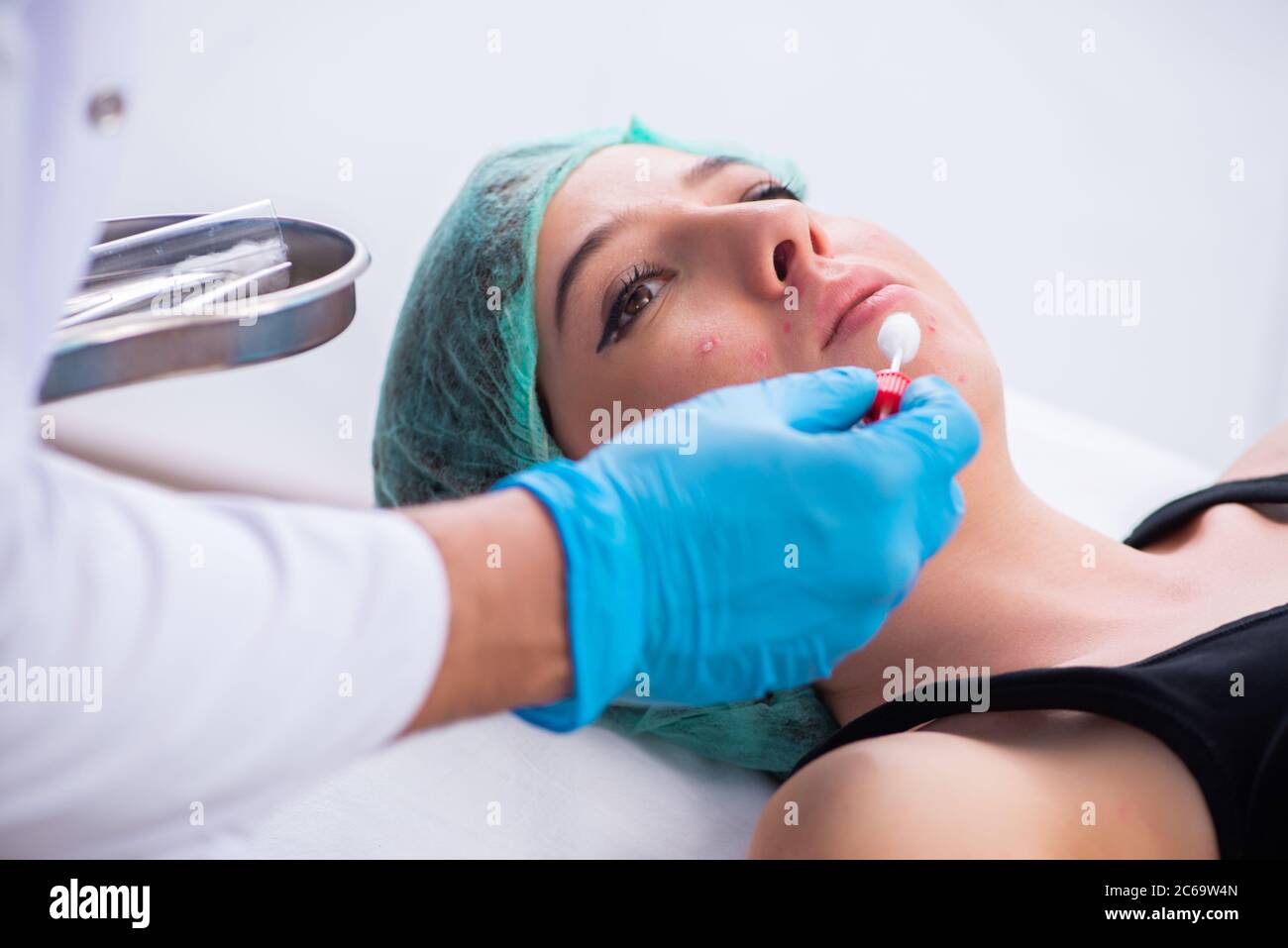 Young woman visiting doctor dermatologist Stock Photo - Alamy
