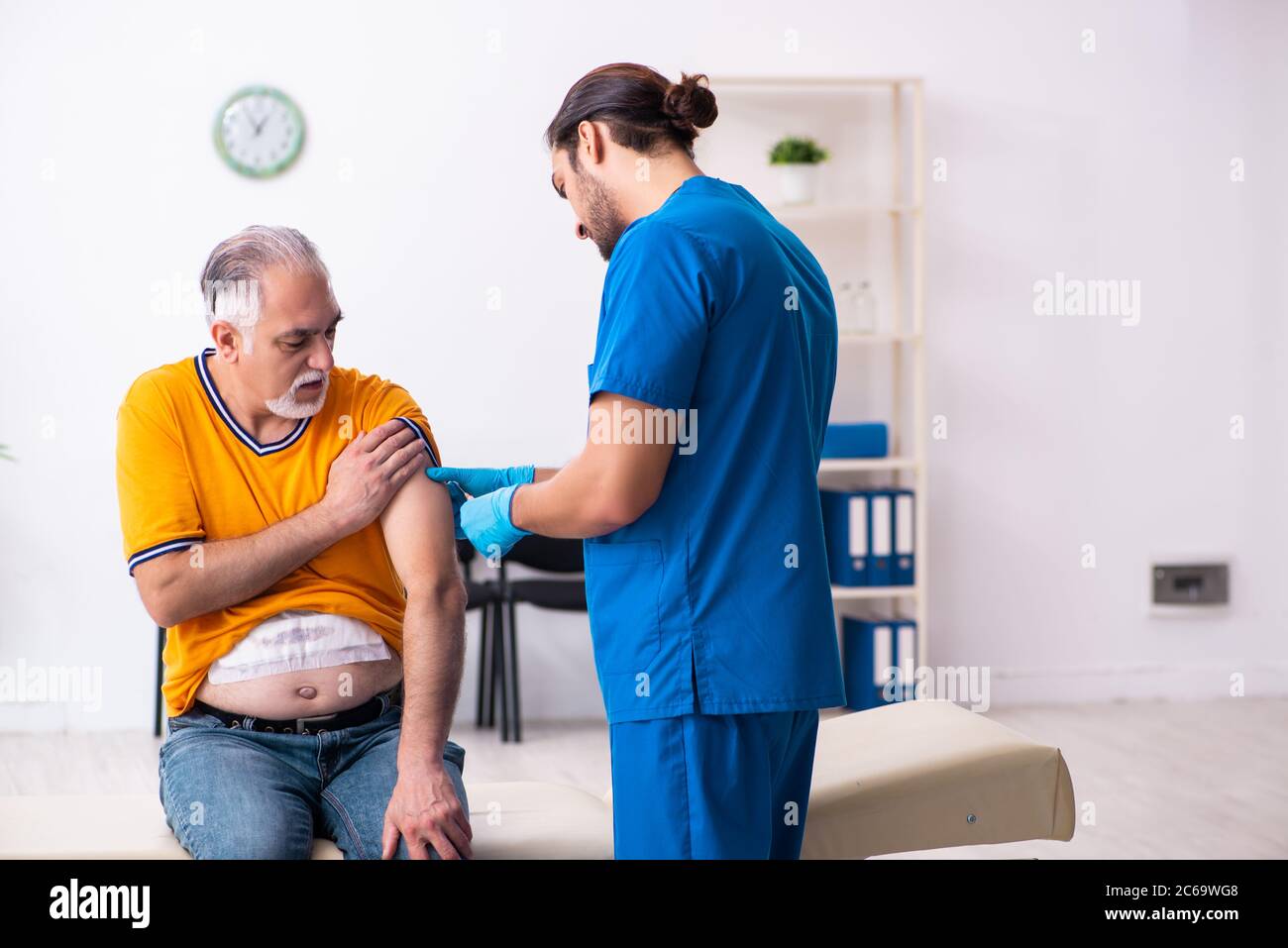 Old man visiting male doctor Stock Photo - Alamy