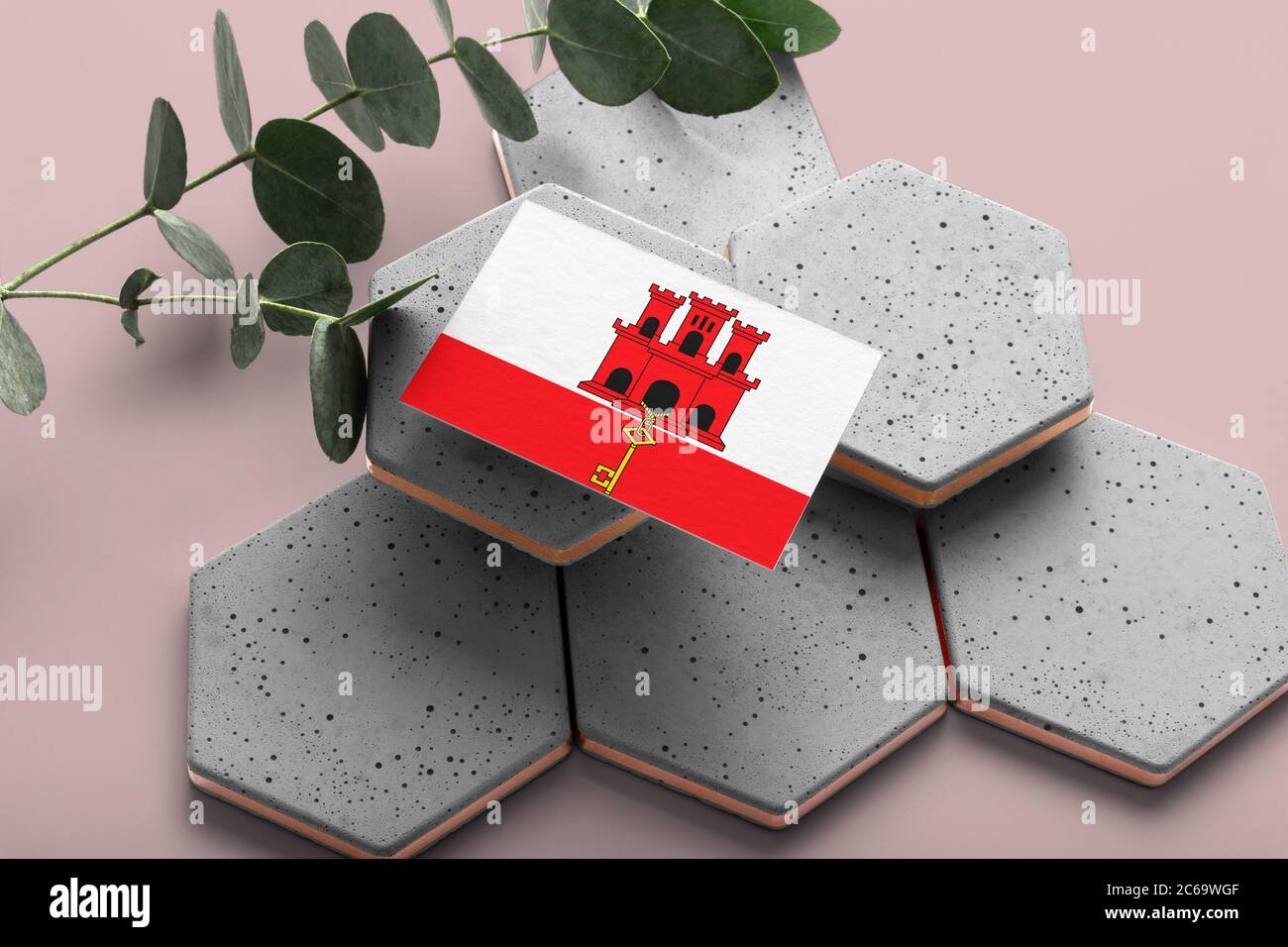 Gibraltar flag on hexagon stylish stones. Pink copy space background ...