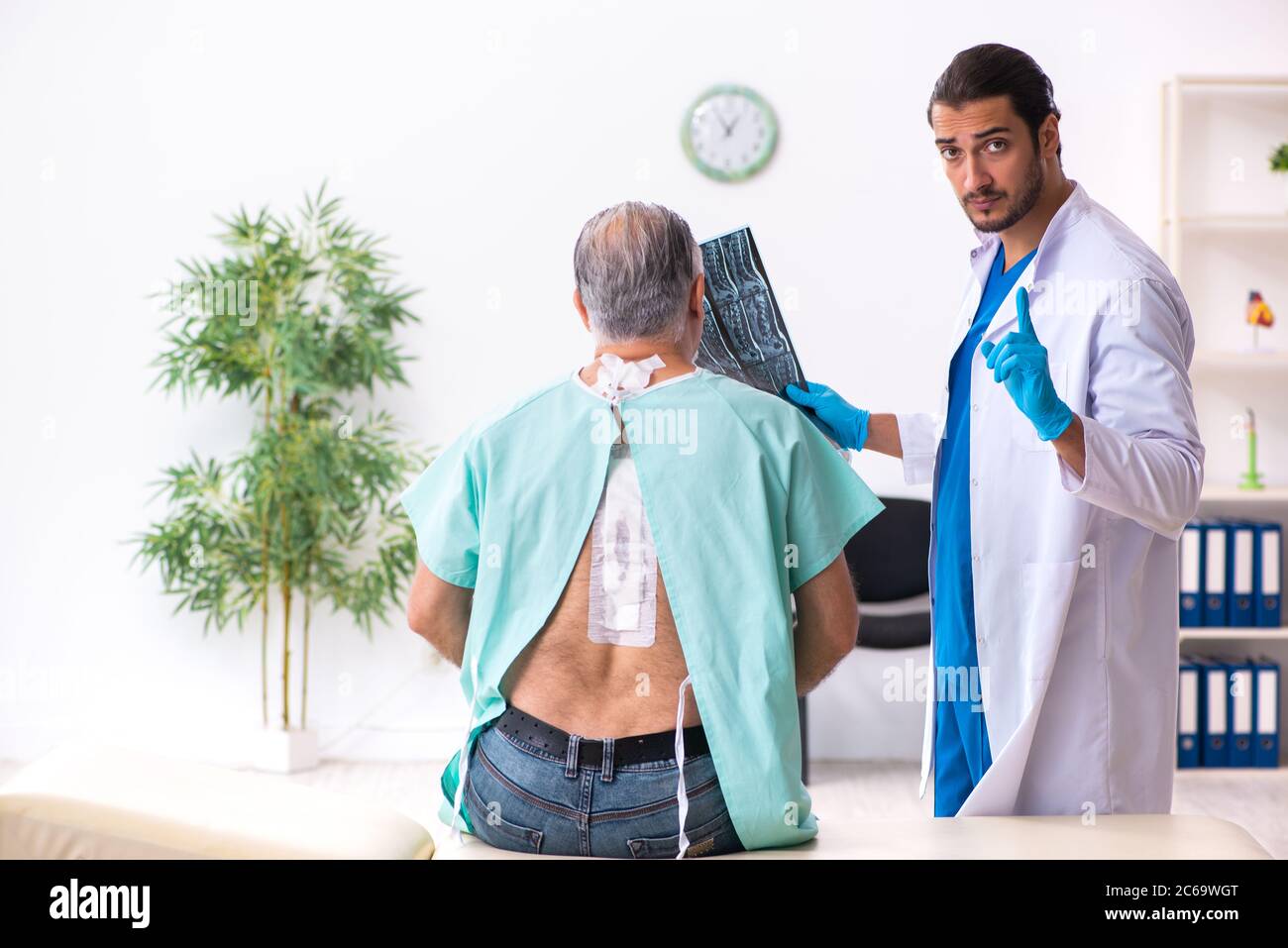 Old man visiting male doctor Stock Photo - Alamy