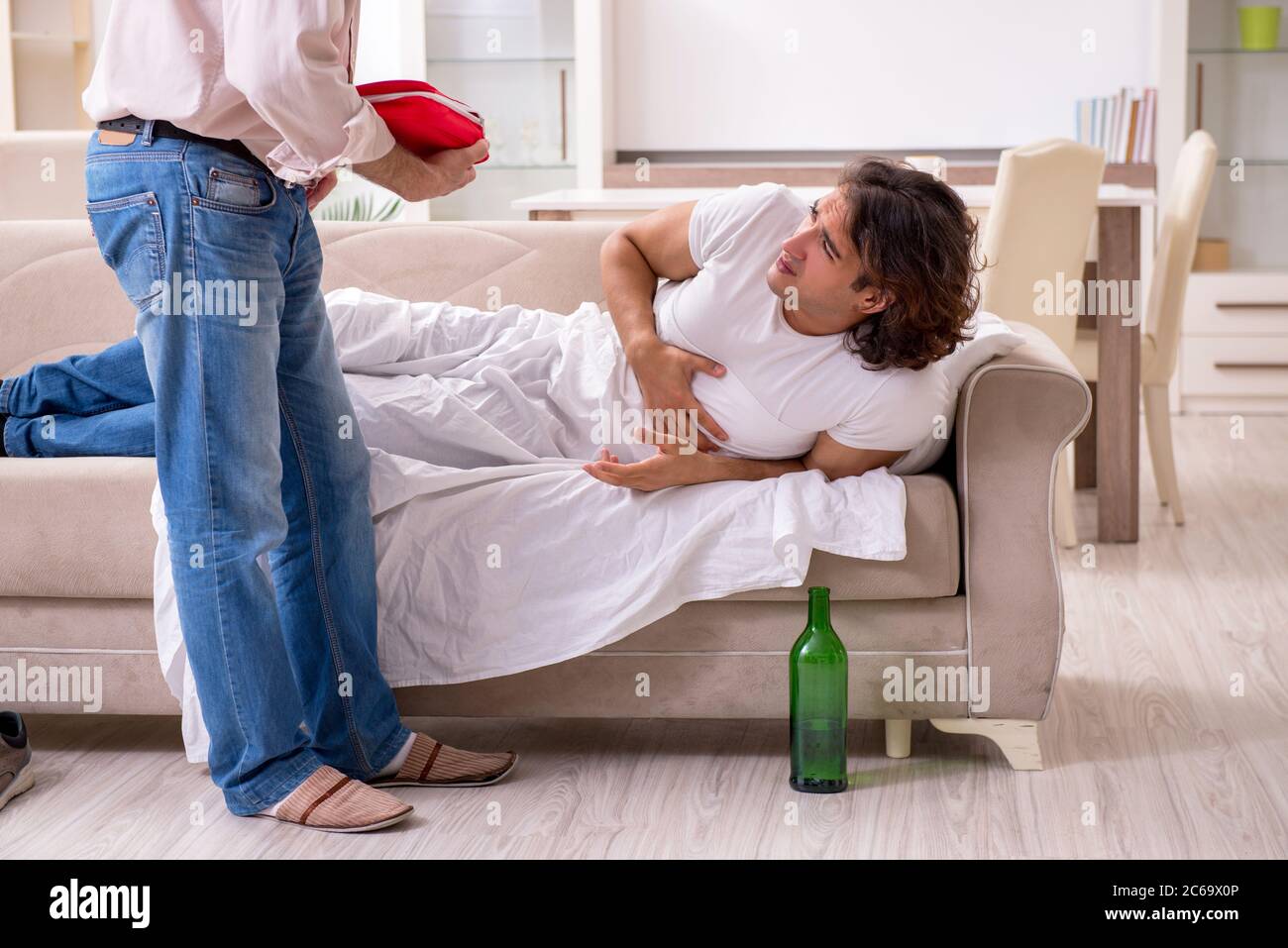 Drinking problems in the family between son and father Stock Photo - Alamy