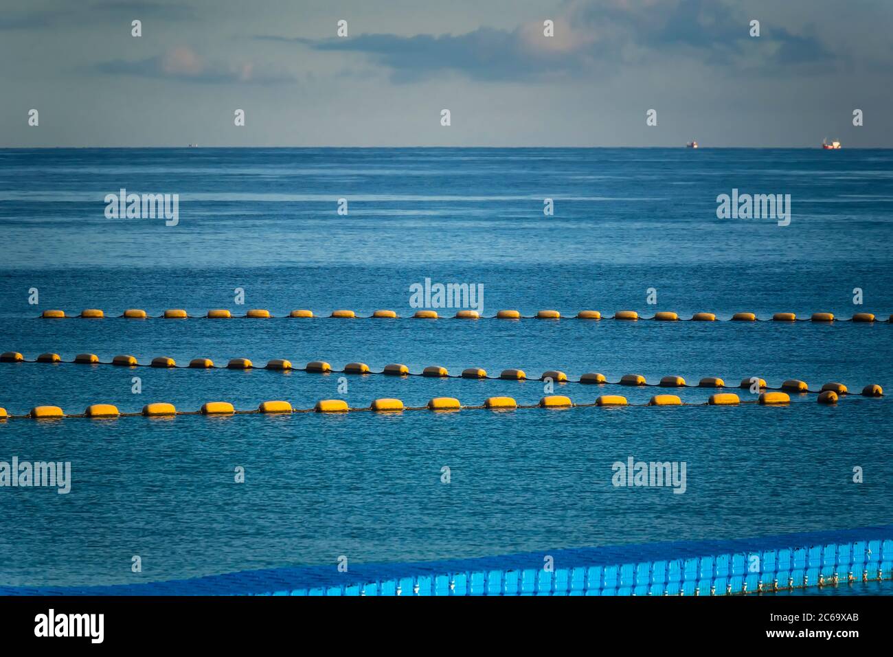 Yellow buoyancy on the beach, sign warning dangerous Stock Photo - Alamy