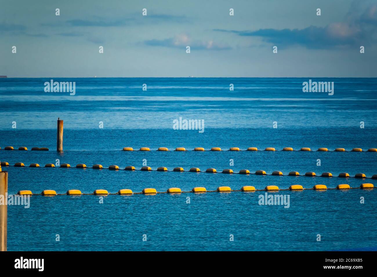 Yellow buoyancy on the beach, sign warning dangerous Stock Photo - Alamy
