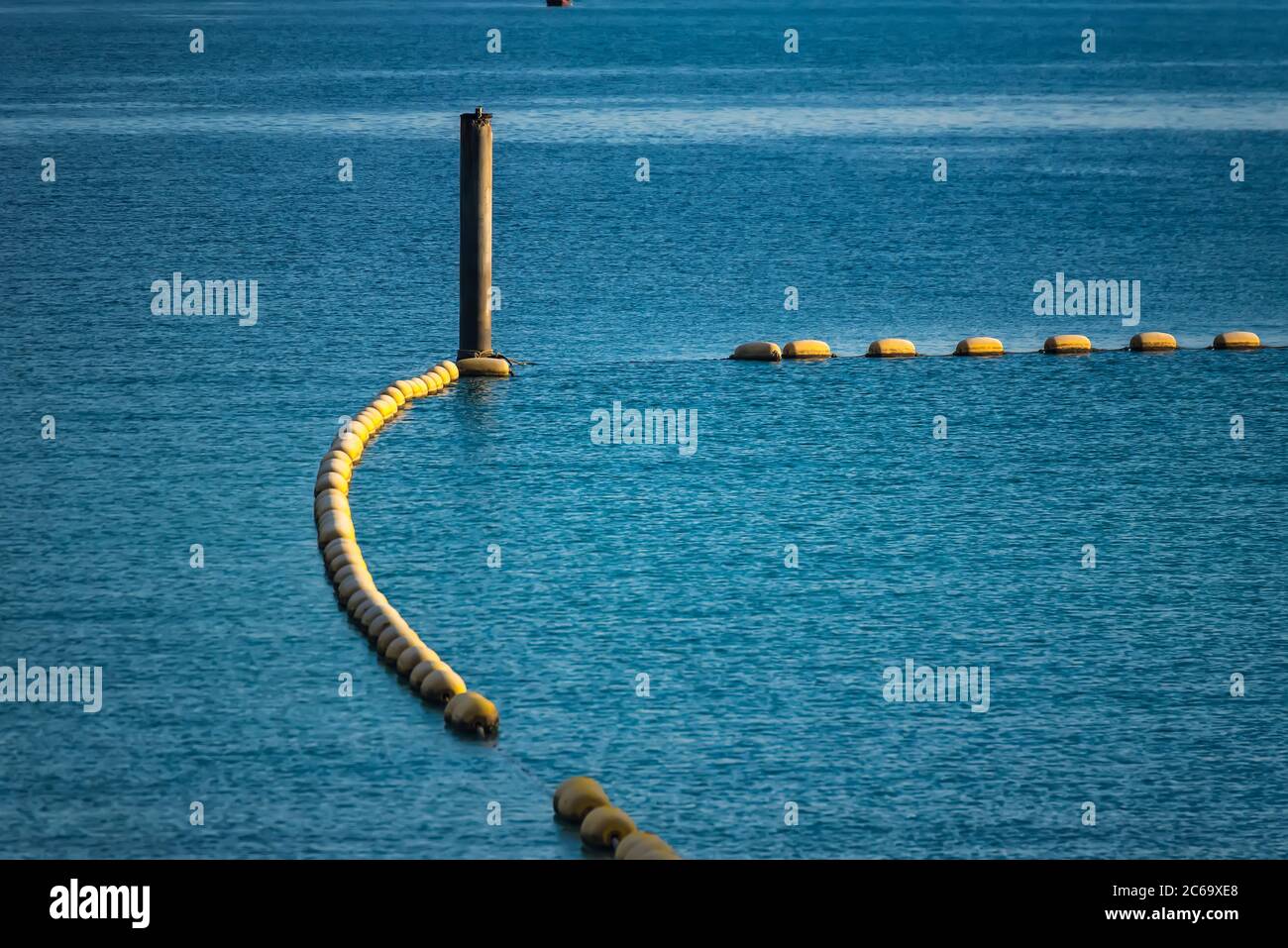 Yellow buoyancy on the beach, sign warning dangerous Stock Photo - Alamy