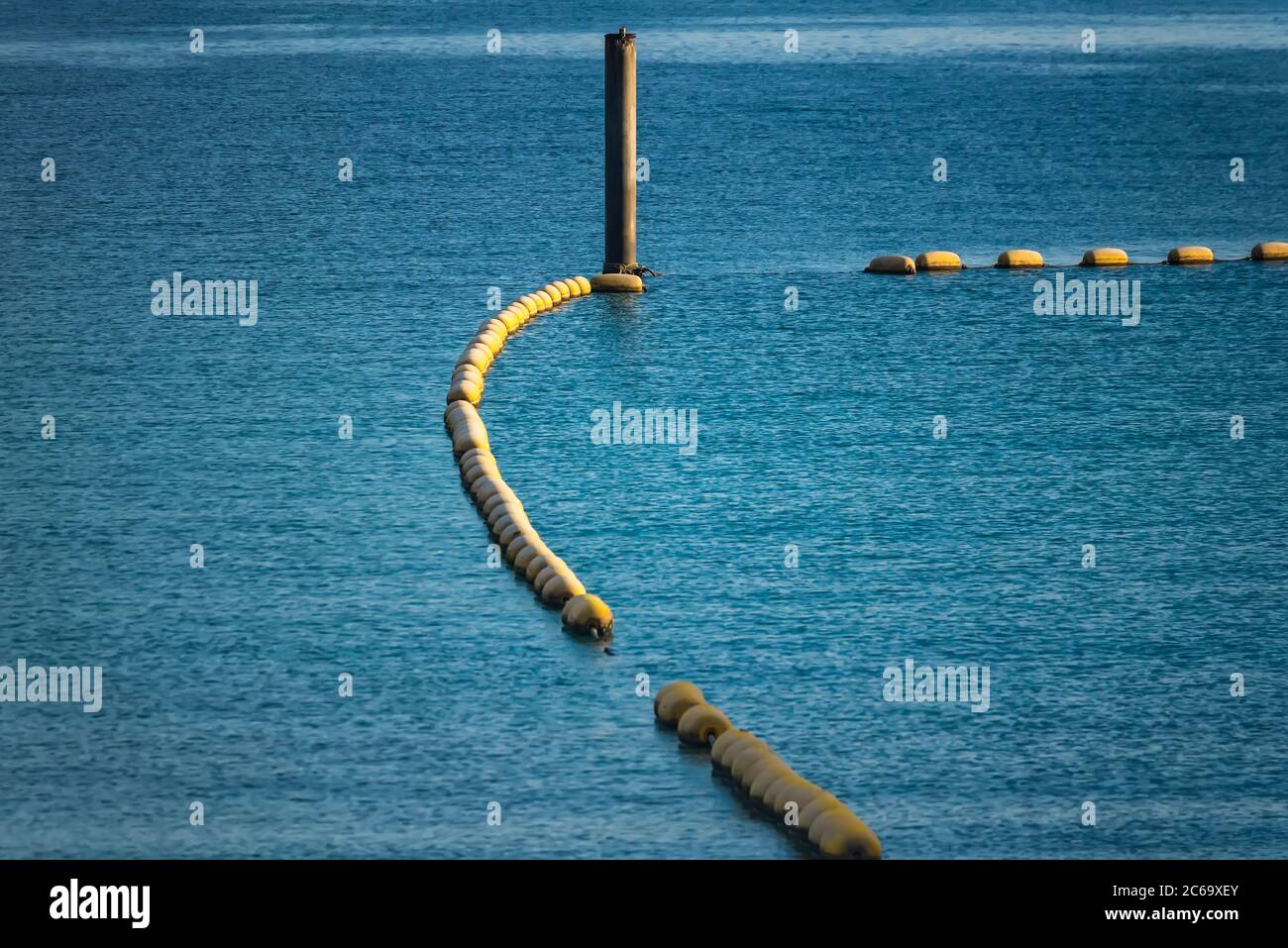 Yellow buoyancy on the beach, sign warning dangerous Stock Photo - Alamy