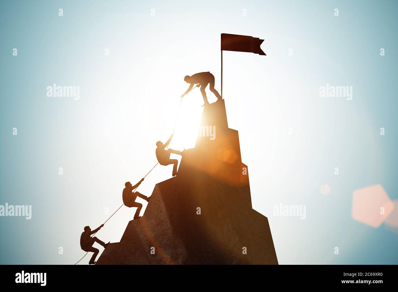 Concept of teamwork with team climbing mountain Stock Photo - Alamy