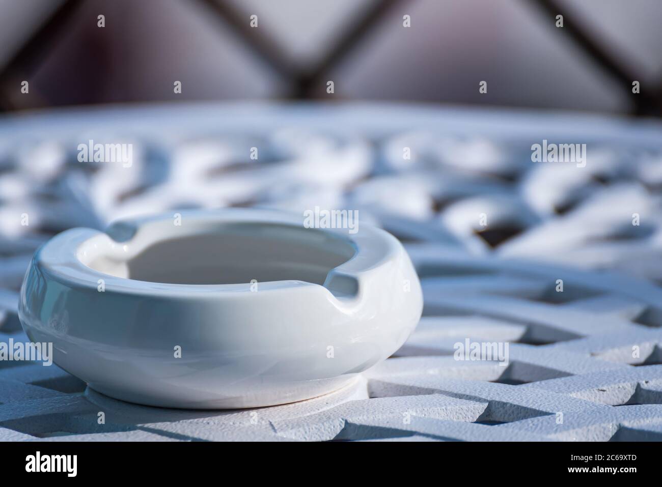 White ceramic ashtray on the metal table Stock Photo - Alamy